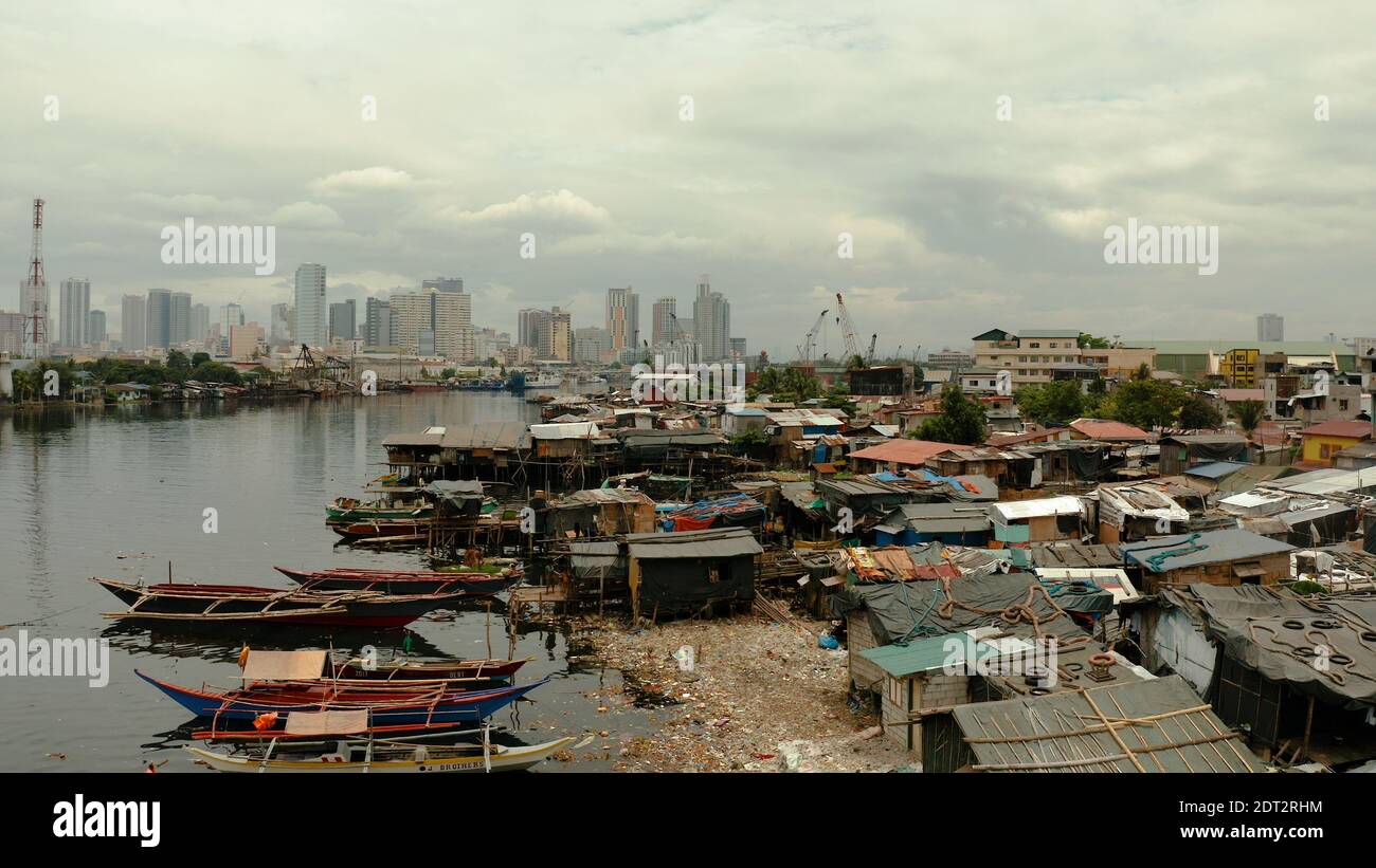 Shacks in the slums of Manila in a poor district and skyscrapers of a ...