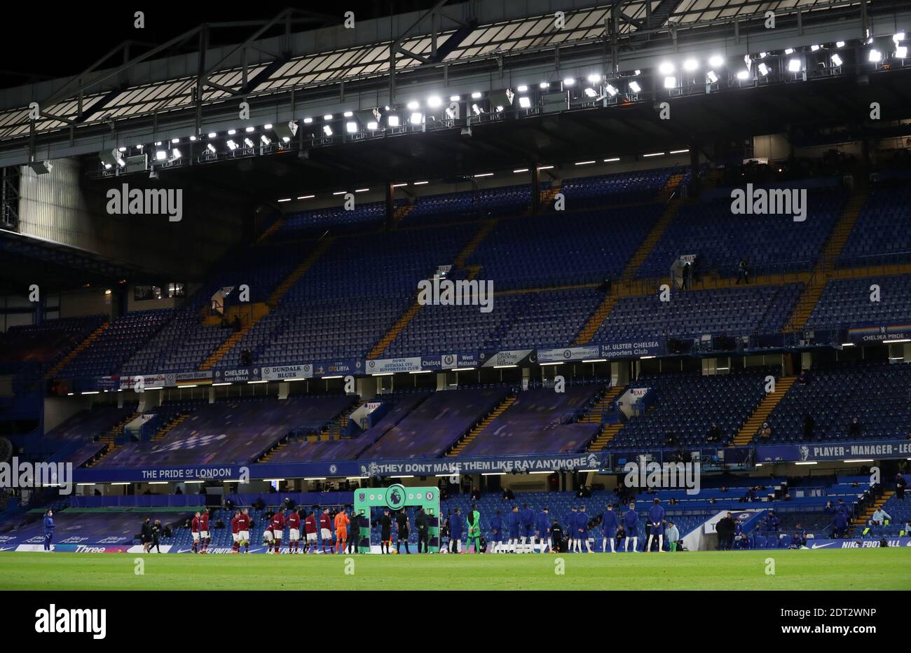 Teams line up infront of an empty stand before the Premier League match ...