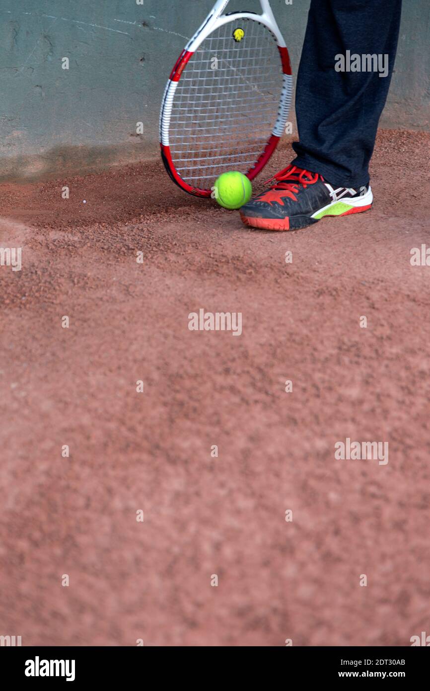 Low Section Of Man With Tennis Ball And Racket Stock Photo - Alamy