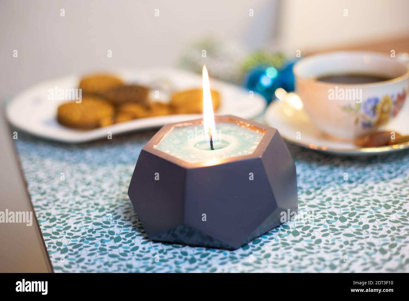 Burning candle on the table Stock Photo - Alamy