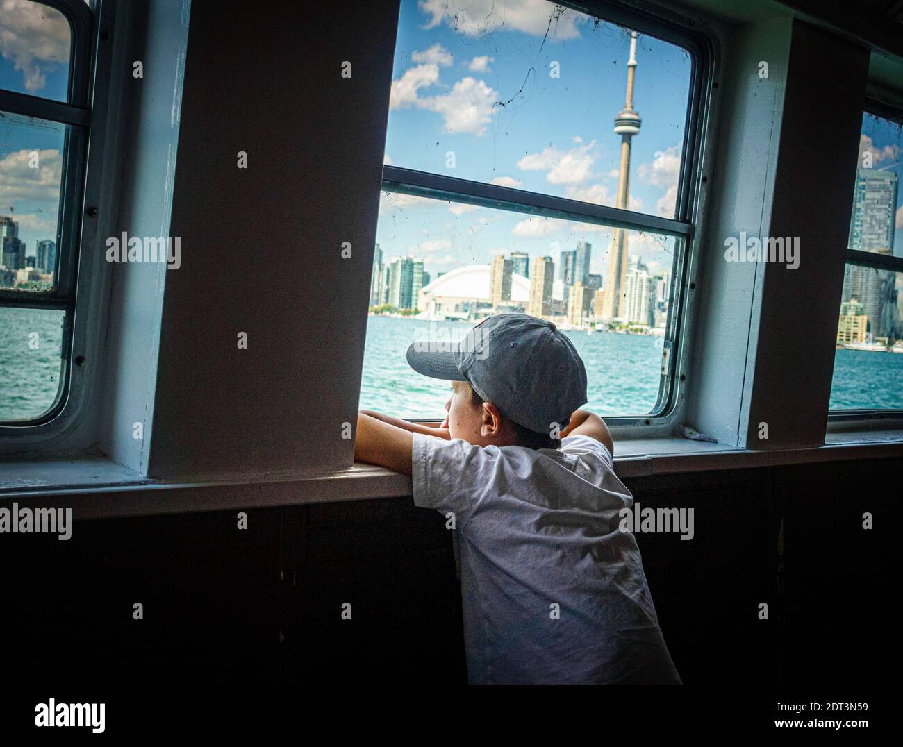 Boy looking out of window on a Ferry Stock Photo - Alamy