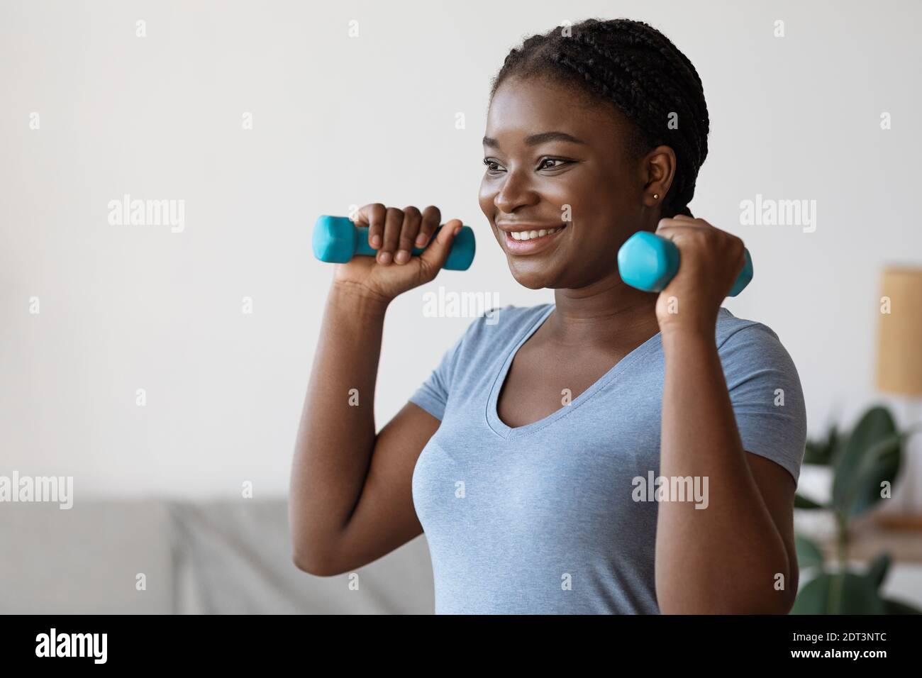 Indoor Sports. Happy African American Woman Working Out With Dumbbells ...