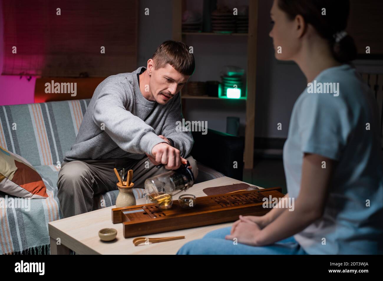 Date in an intimate setting of a tea house. A man and a woman drink ...