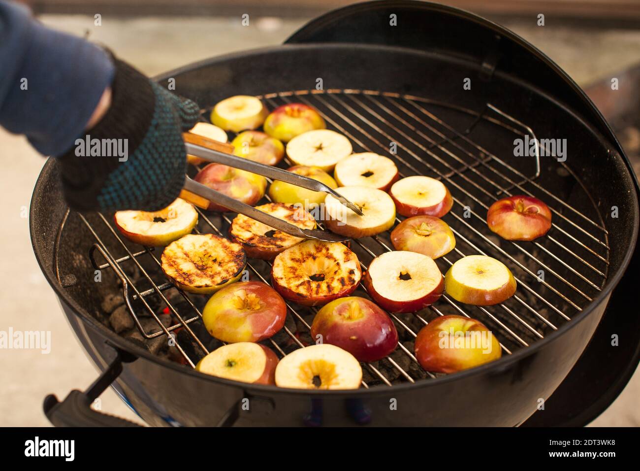 The process of making a dessert of apples on the grill. Fried apples ...
