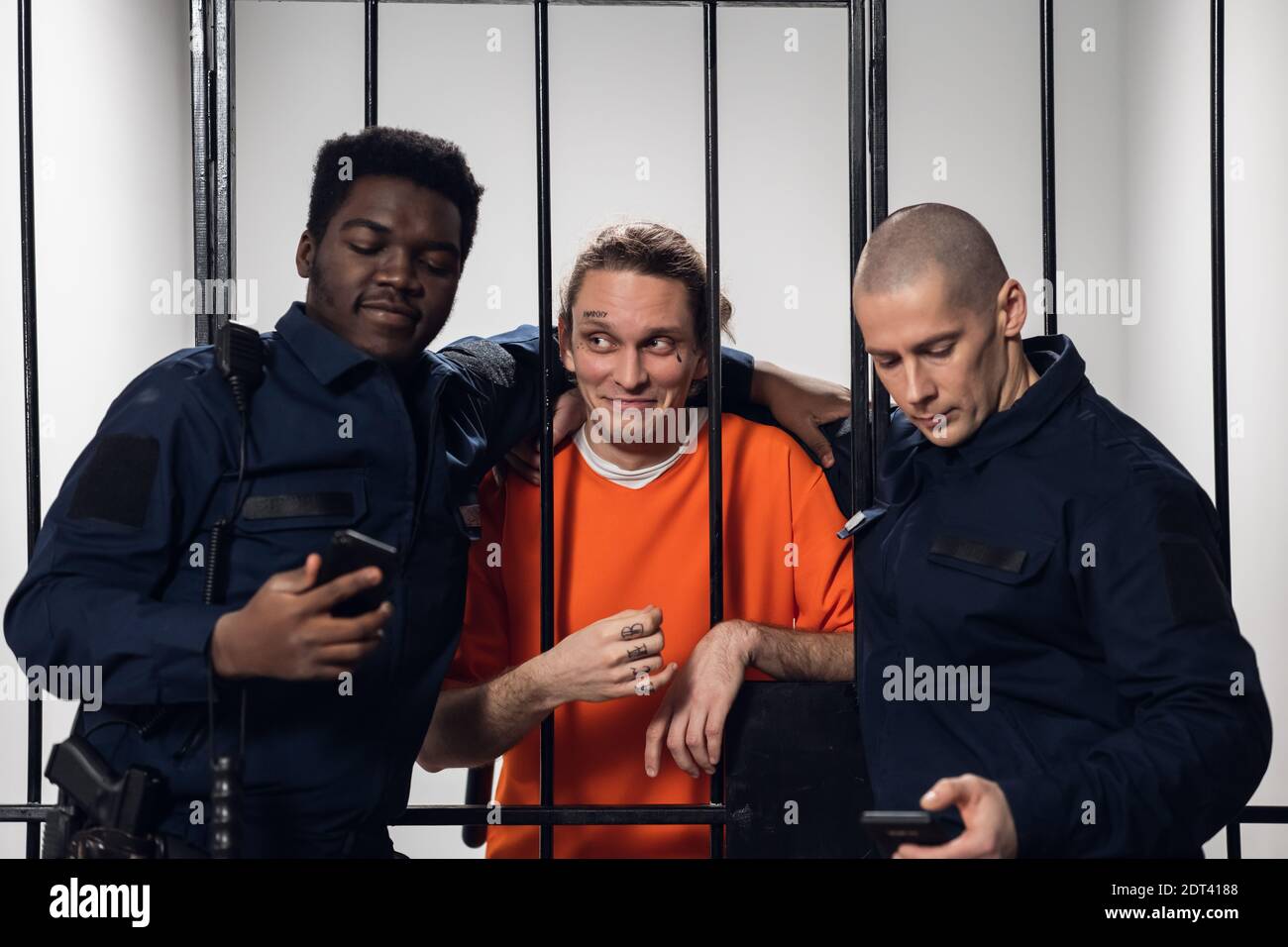 A prisoner with tattoos on his face takes a selfie with his fellow ...