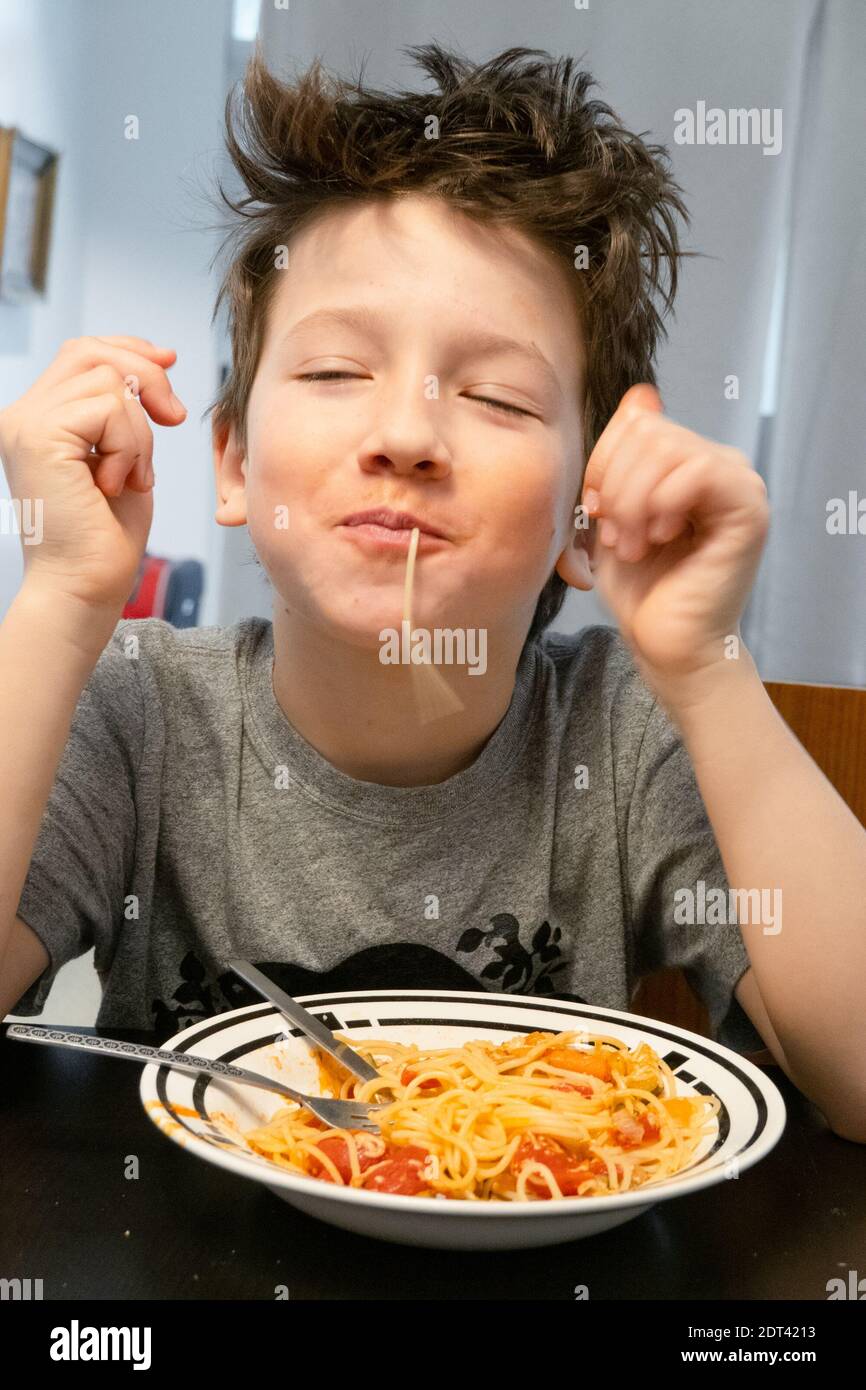 Boy eating noodles hi-res stock photography and images - Alamy