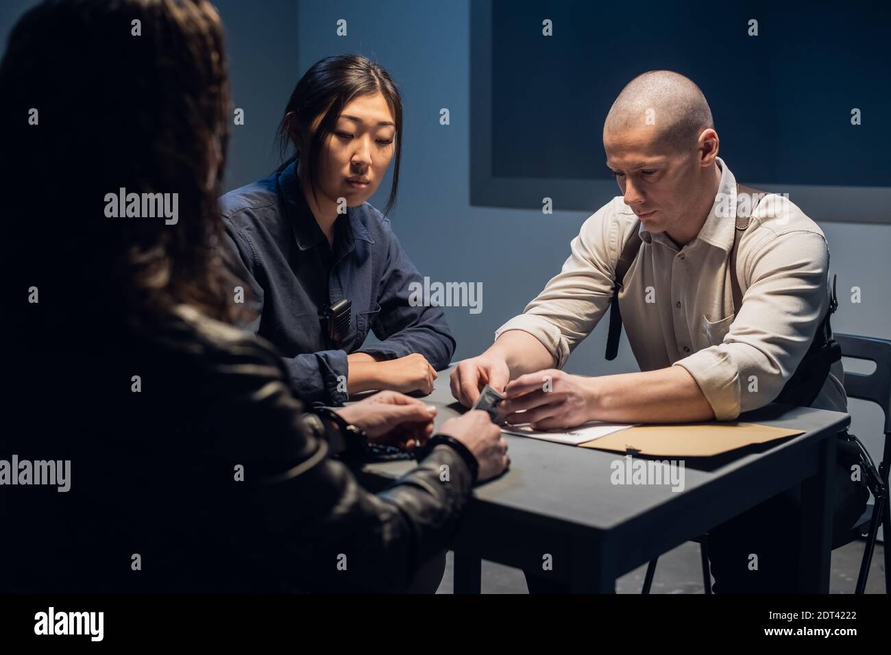 Two police officers a man and a woman are questioning the alleged ...