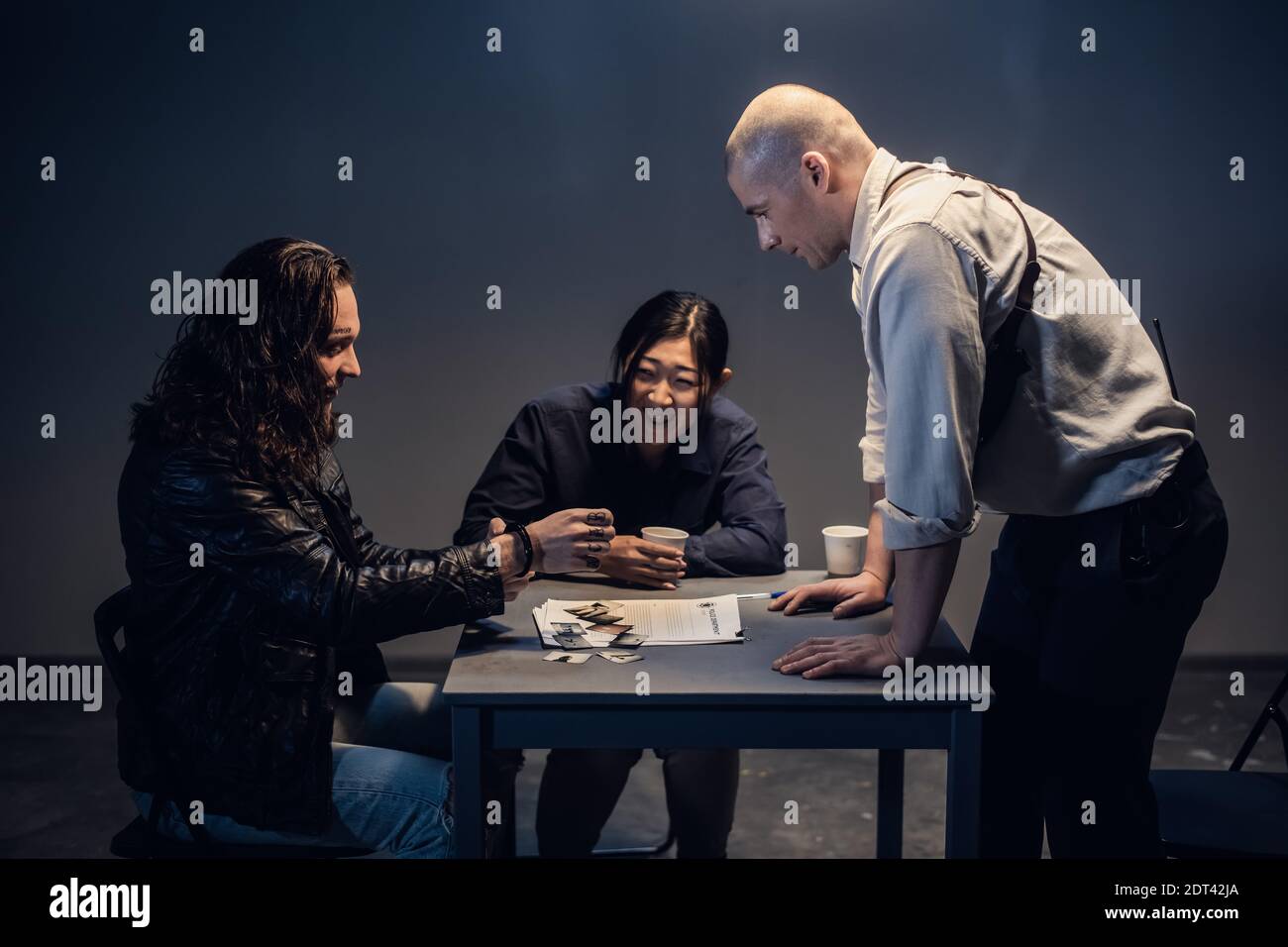 A police detective at the station and his partner, an asian woman ...