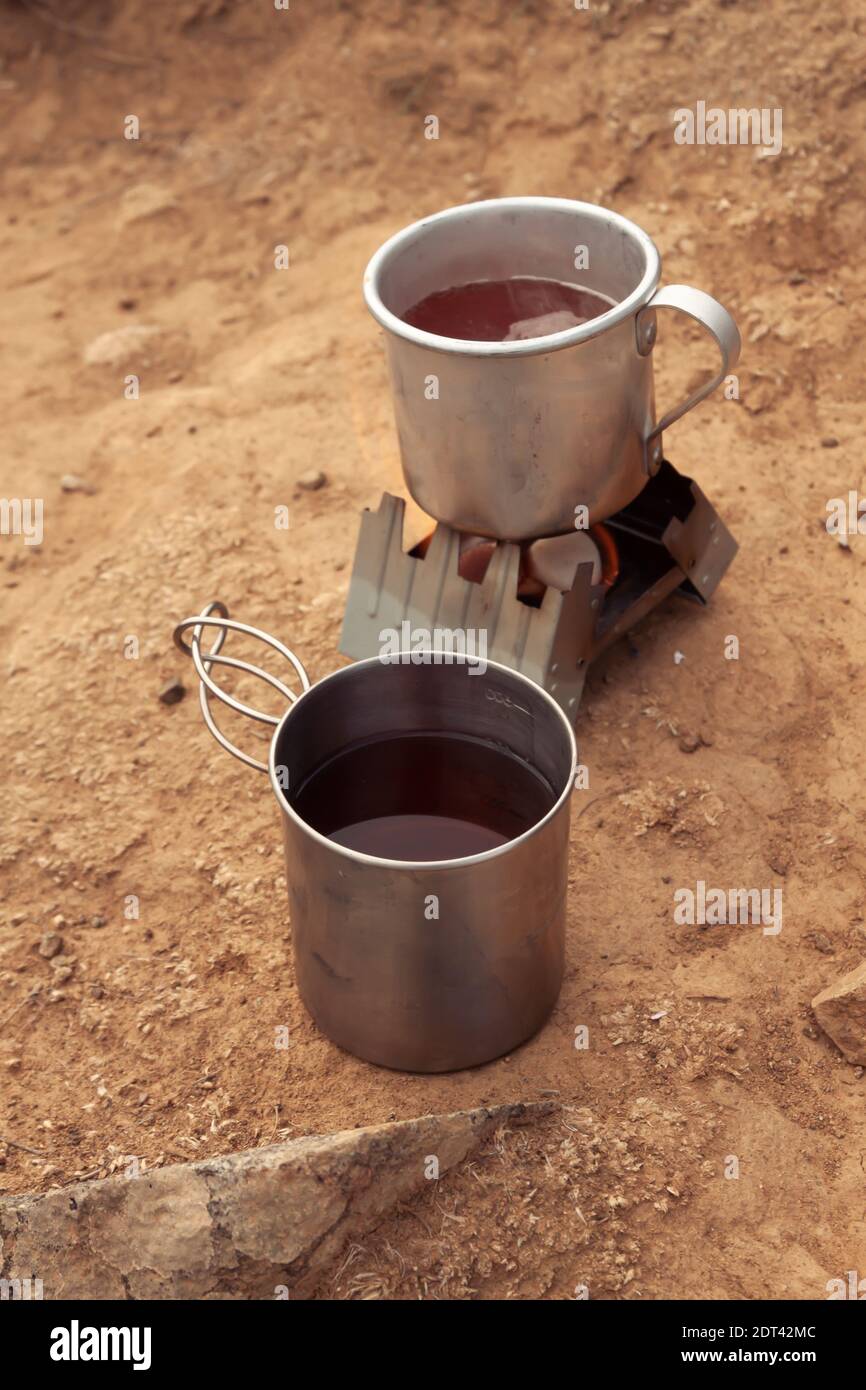Iron, tourist mugs on an open fire during a camping trip Stock Photo ...