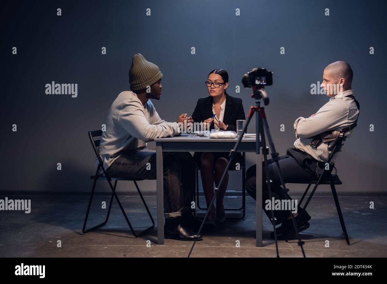 In the interview room, there is a conversation with a drug dealer, the ...