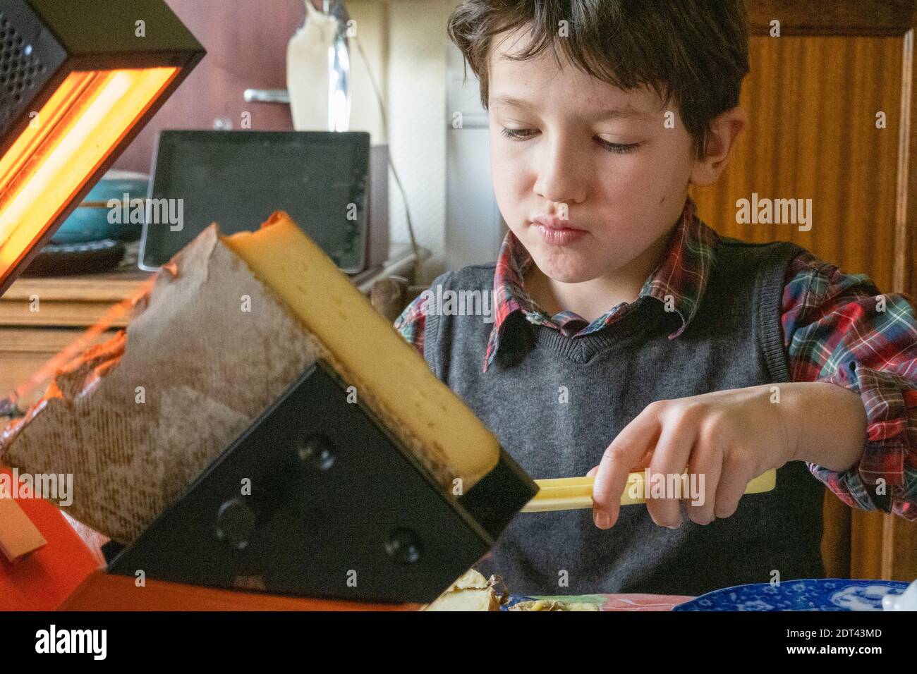 Close-up of a boy looking at small object at home Stock Photo - Alamy