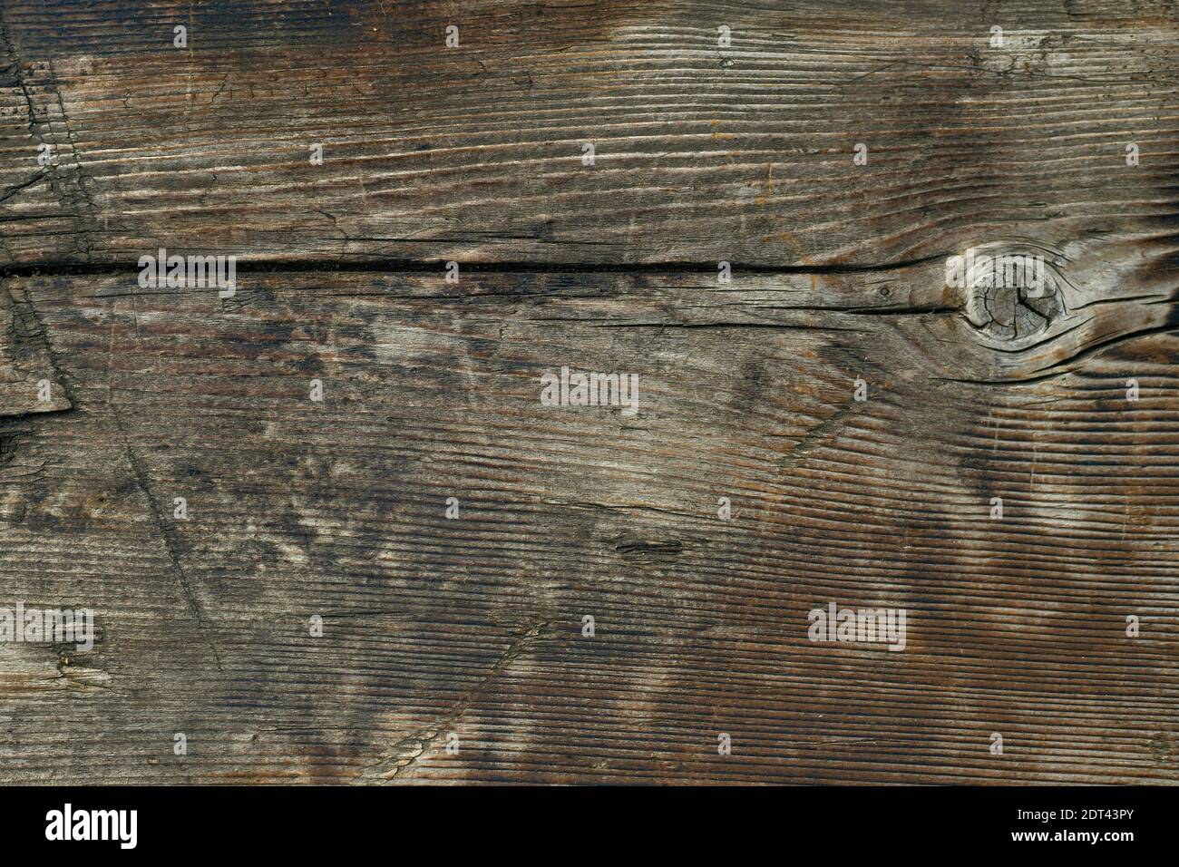 A wooden aged background from a one piece board with bitches and dents ...