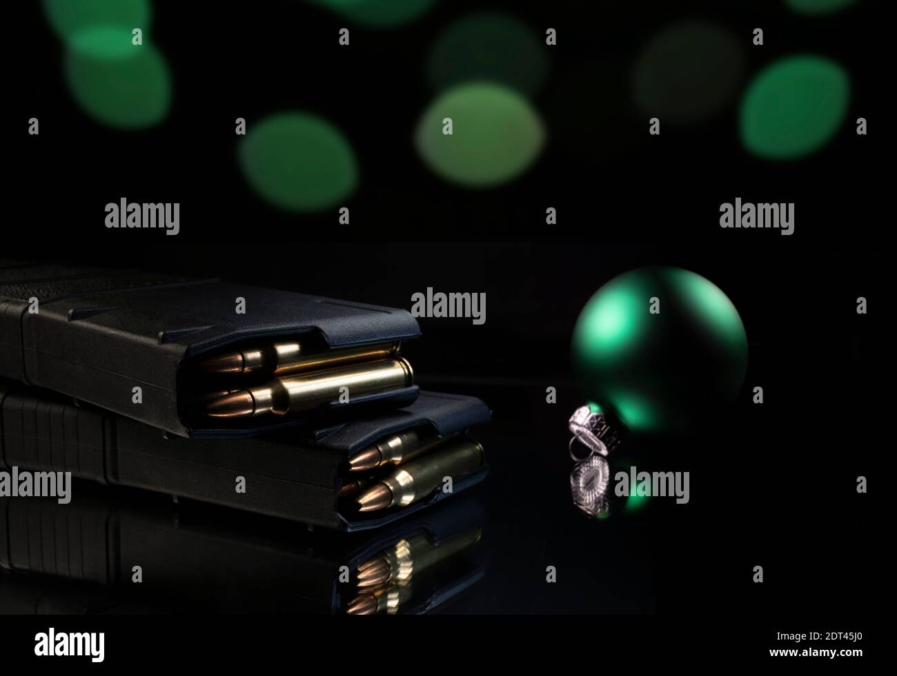 Loaded AR-15 magazines on a dark reflective background with green ...