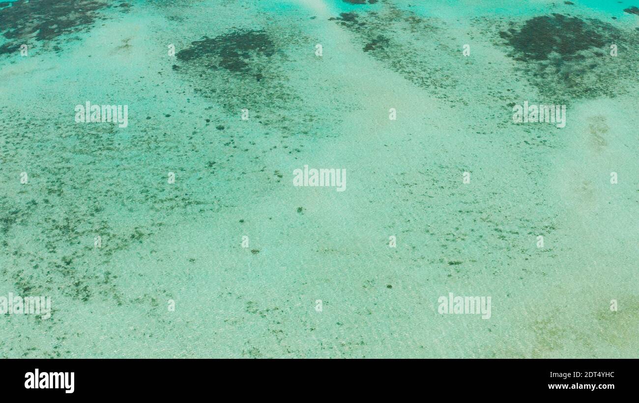 Turquoise lagoon surface on atoll and coral reef, copy space for text ...