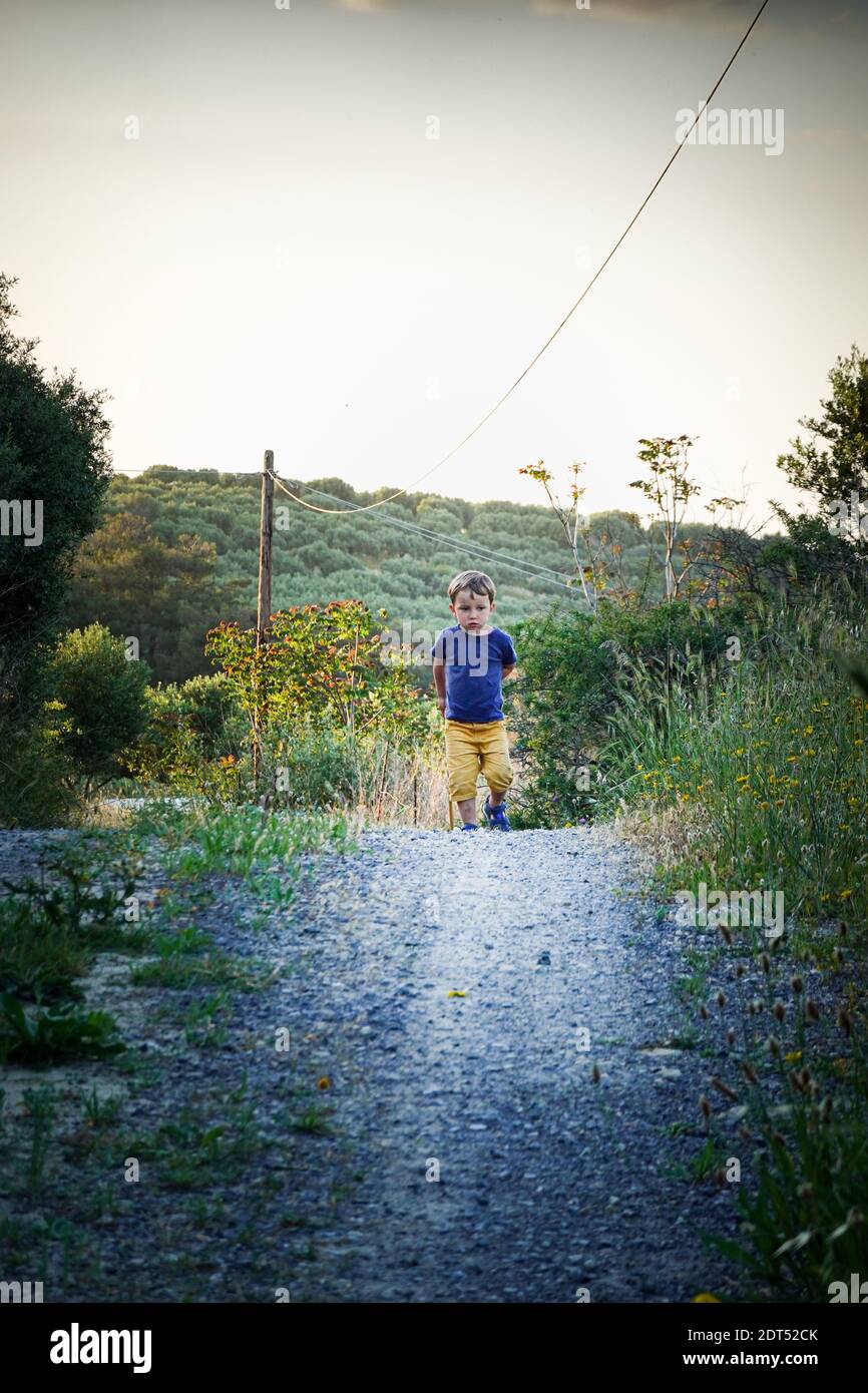 Child walking in forest path alone Stock Photo - Alamy