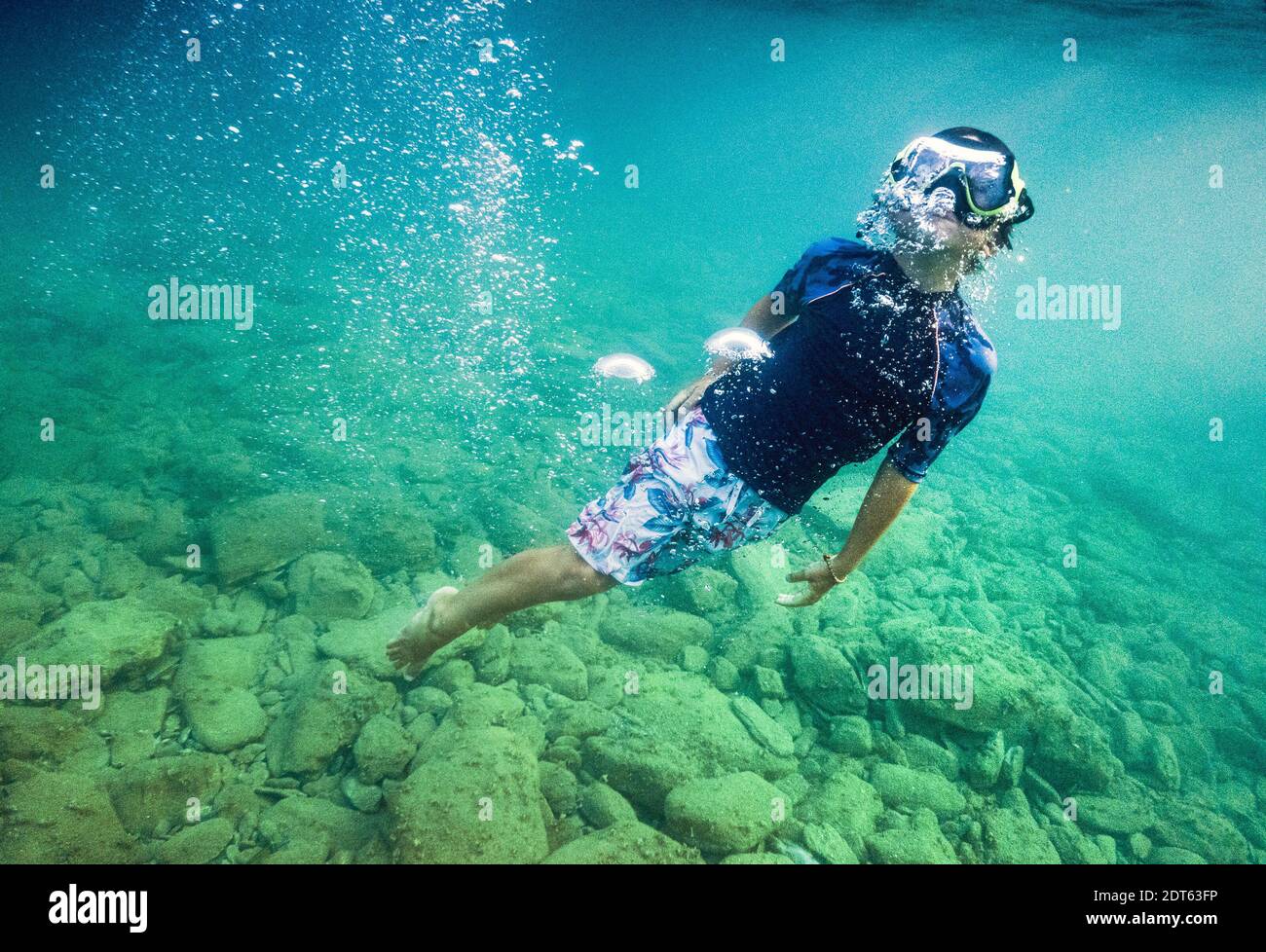 Boy wearing scuba mask swimming underwater Stock Photo - Alamy