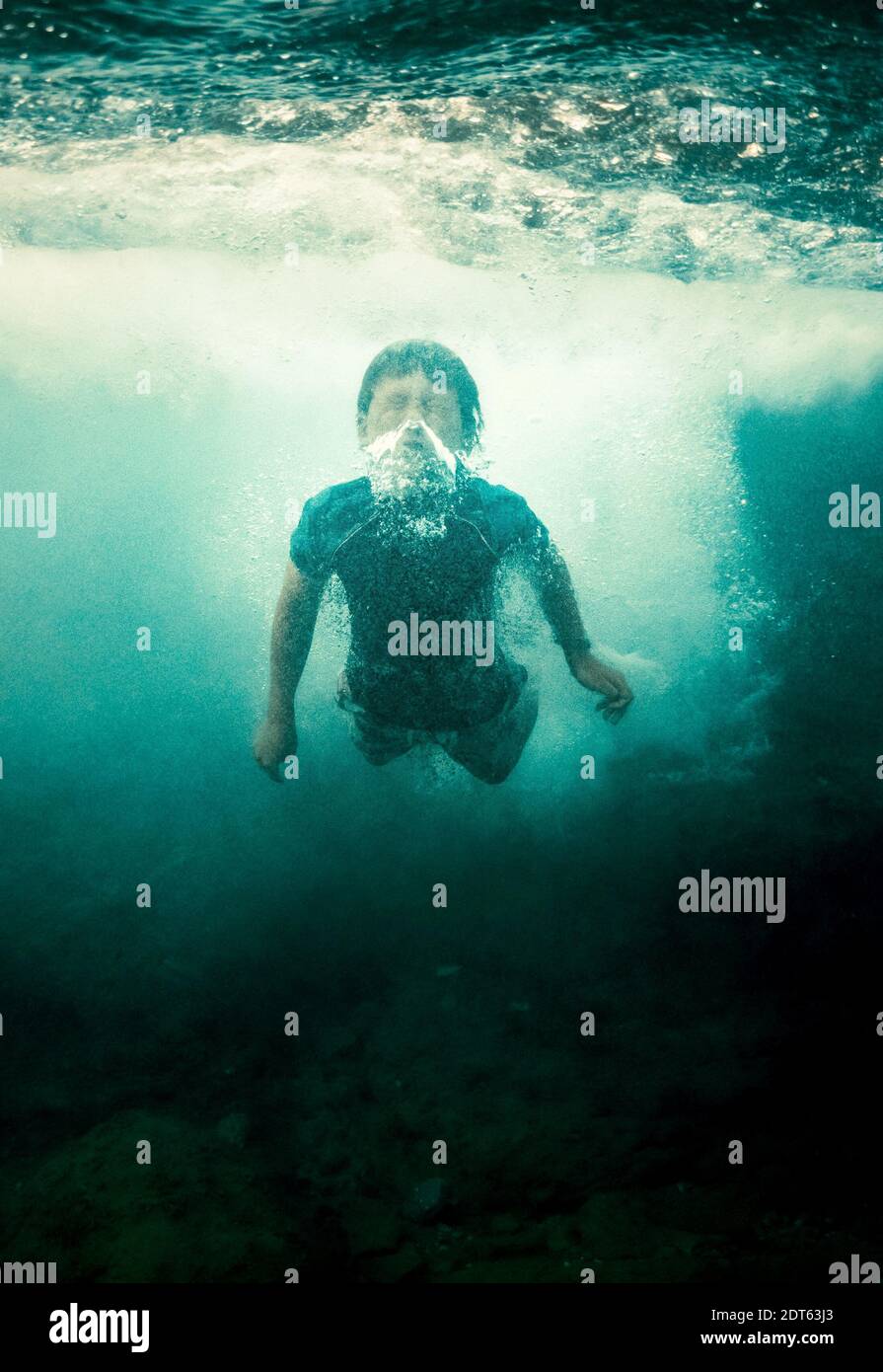 Young boy diving into water Stock Photo - Alamy