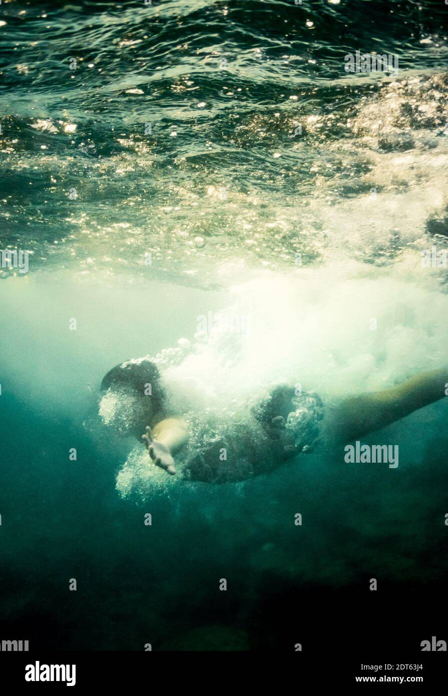 Young boy diving into water Stock Photo - Alamy