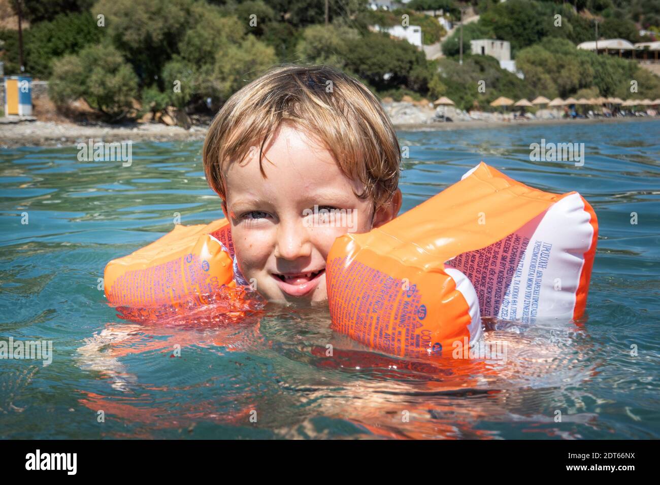 Happy boy having fun while swimming in sea Stock Photo - Alamy