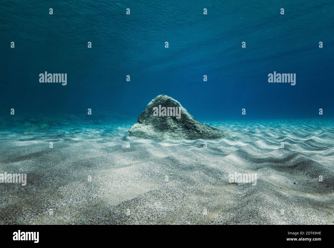 View of underwater stone with rippled sand Stock Photo - Alamy