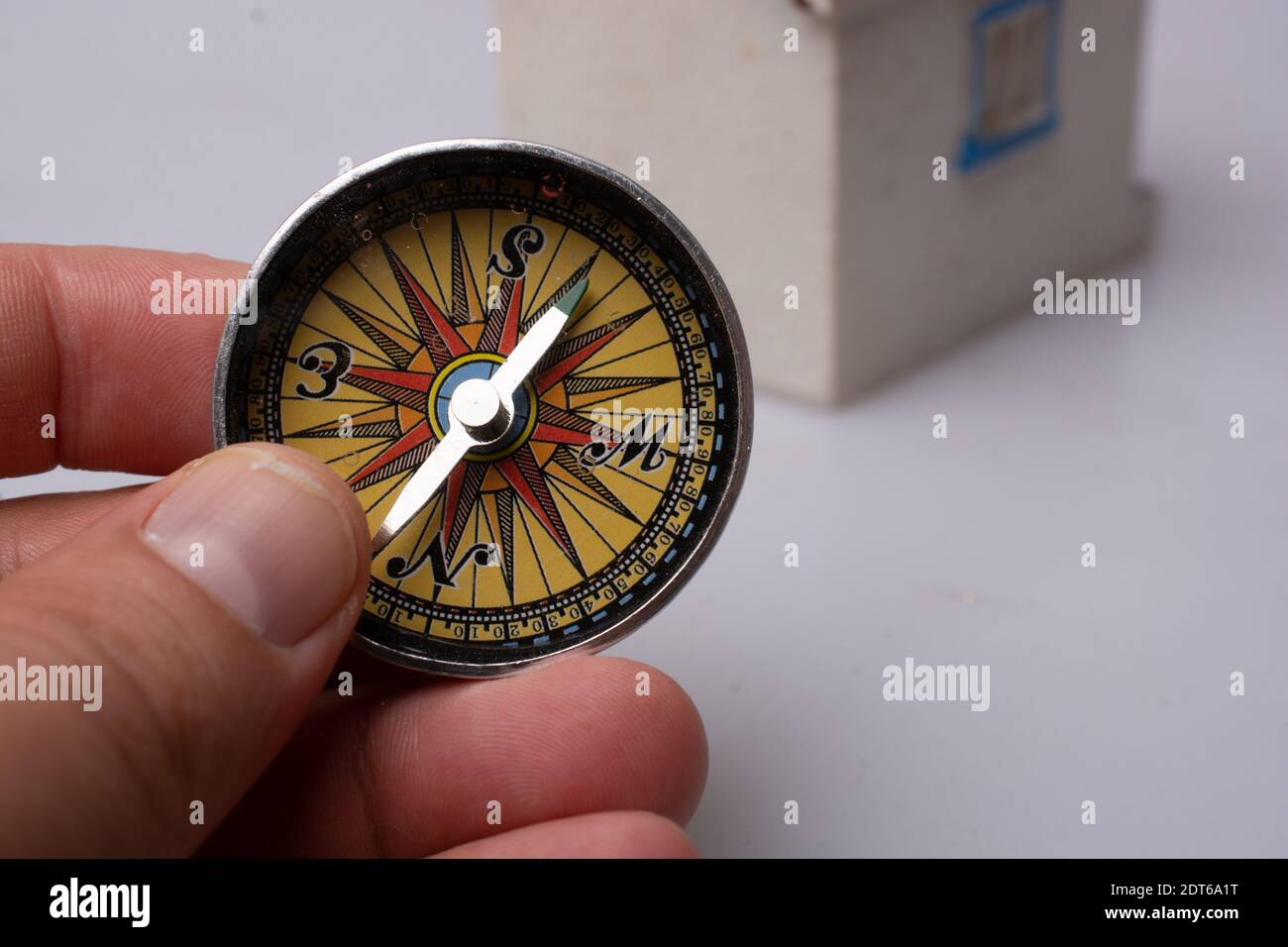 Compass tool in hand o as travel concept Stock Photo - Alamy