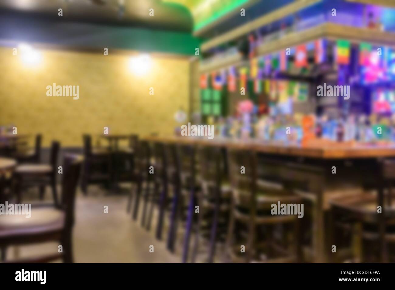 Blurred interior of an empty cafe. Various drinks at the bar in a modern pub. Presentation mock ...