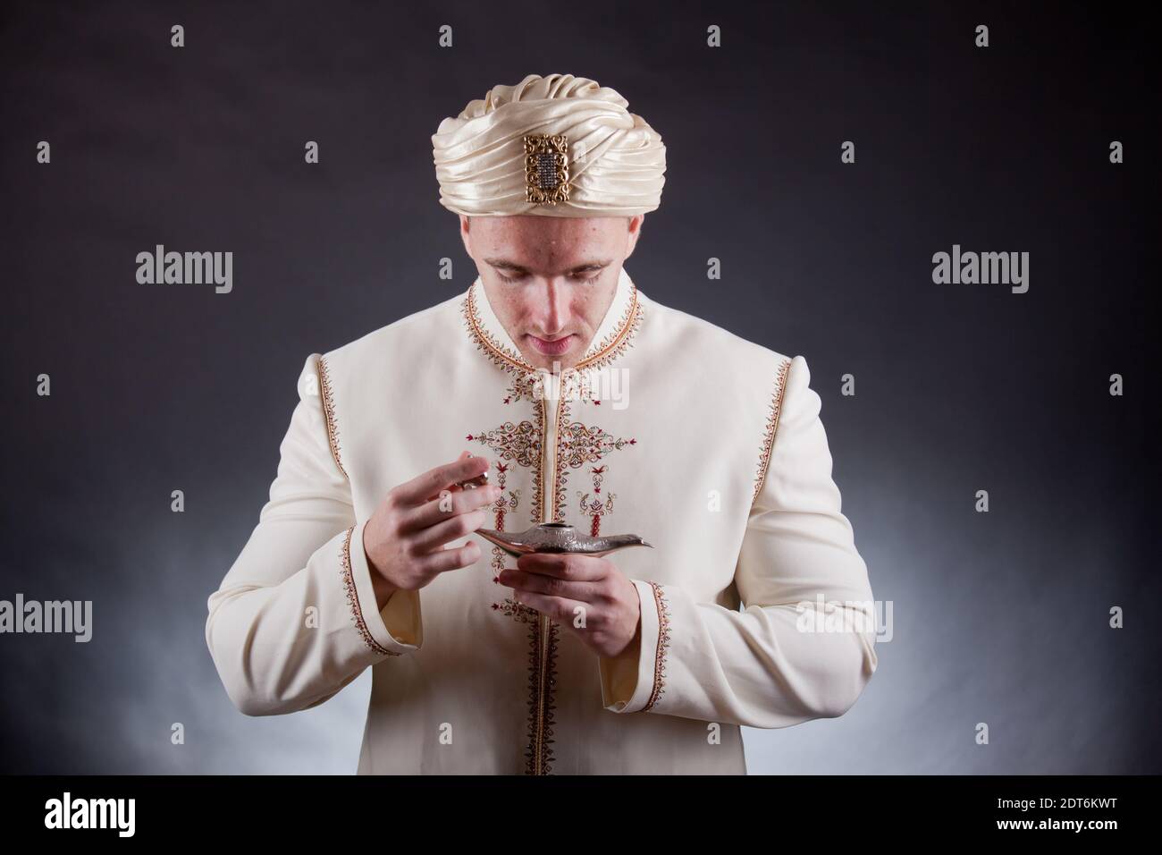 Young man in oriental costume with magic lamp Stock Photo - Alamy