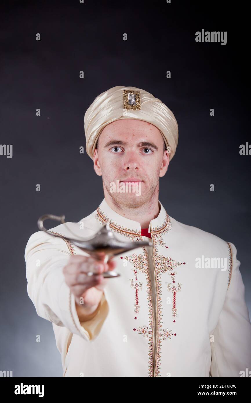 Young man in oriental costume with magic lamp Stock Photo - Alamy