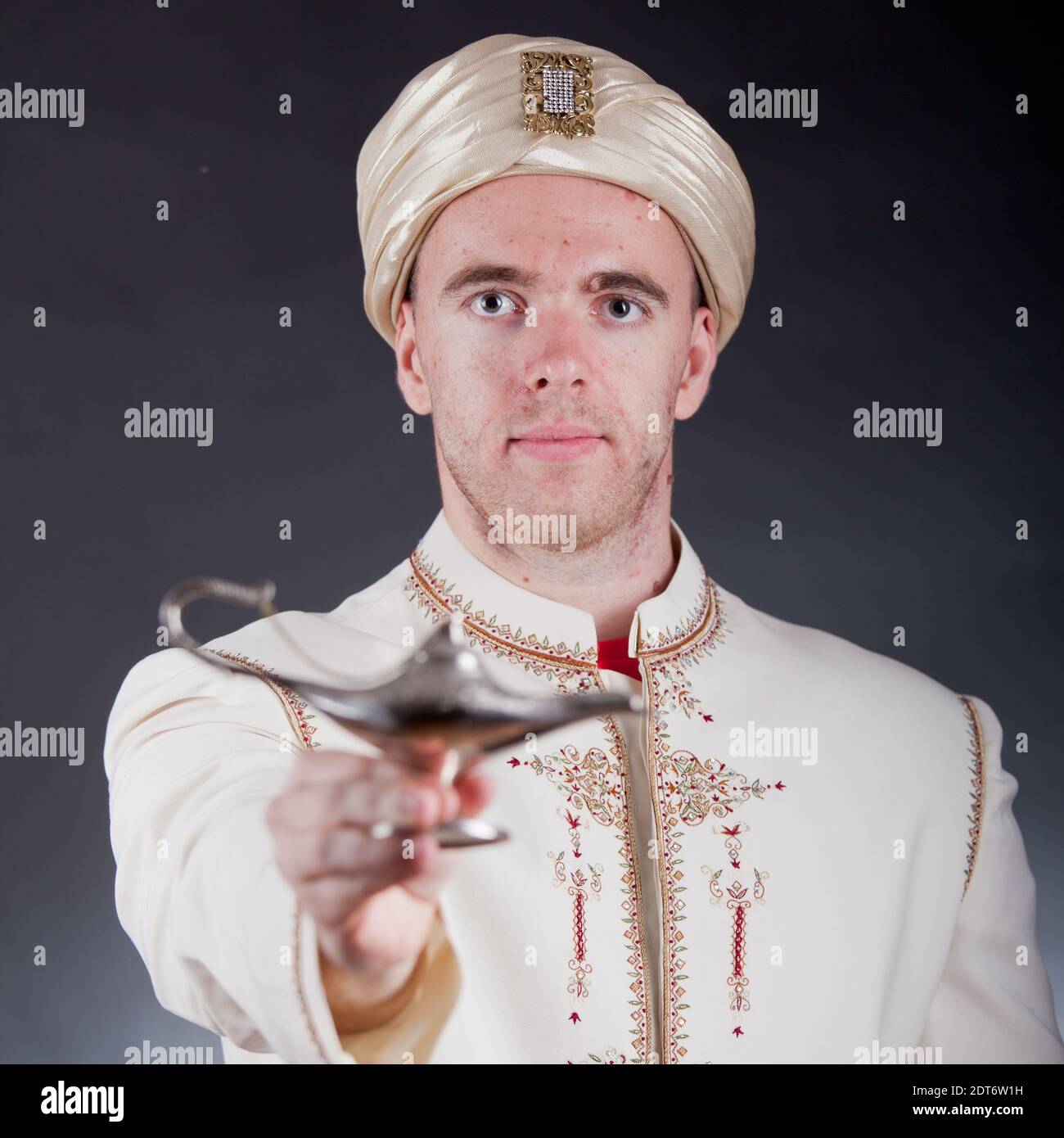 Young man in oriental costume with magic lamp Stock Photo - Alamy