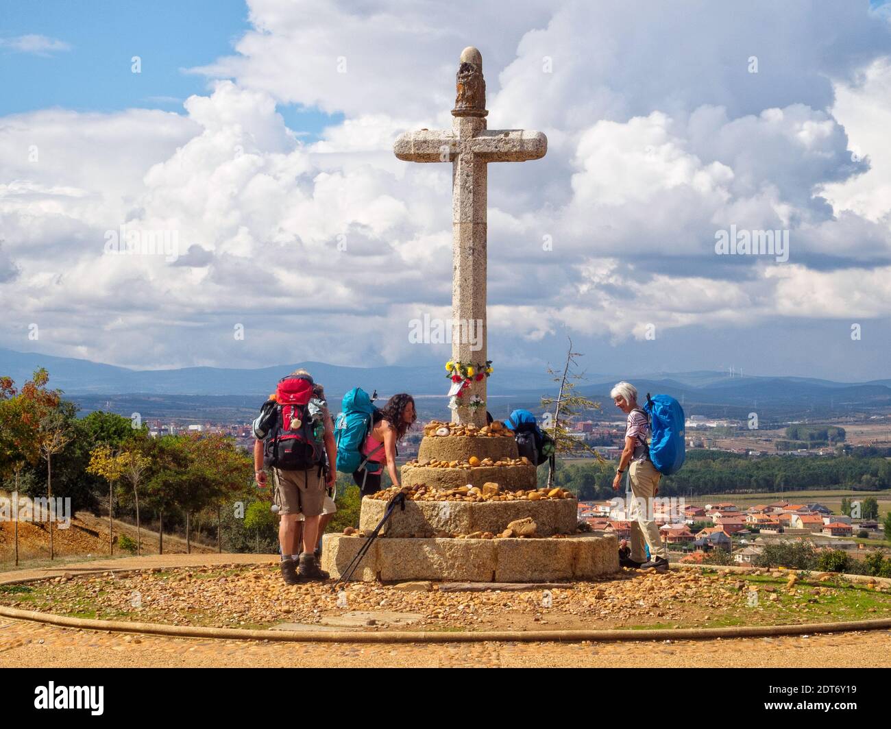 Pilgrims at the stone cross commemorating the 5th century Bishop ...