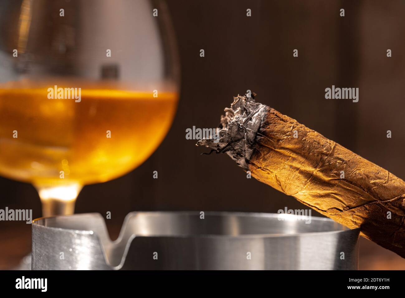 Glass of whisky and lighted cigar in an ash tray Stock Photo - Alamy