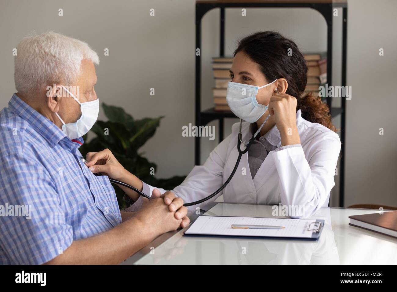 Caring female doctor listen to mature patient heart Stock Photo - Alamy