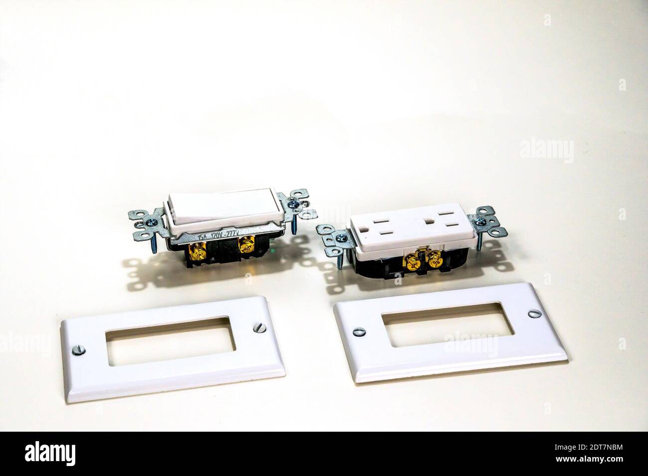 Switch and socket isolated against white background with covers lying ...