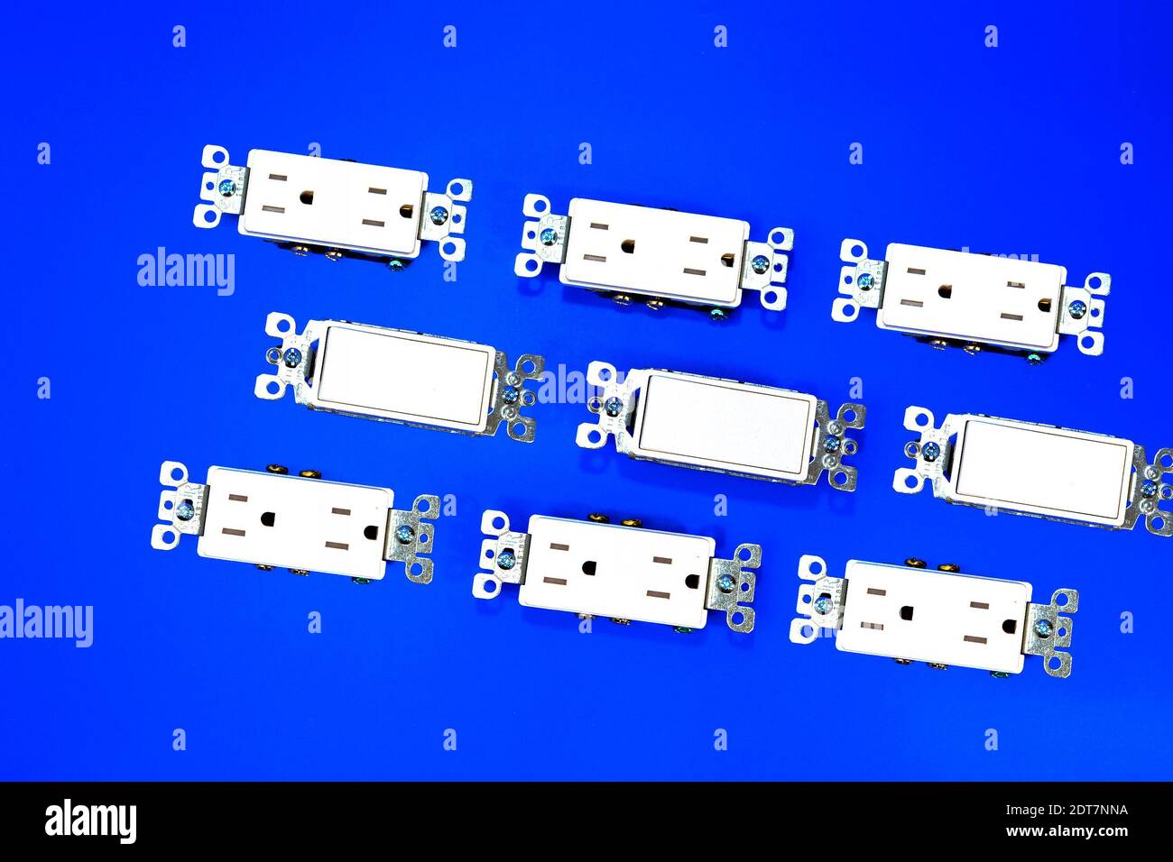 Three switches and six sockets without covers, photo against a blue ...