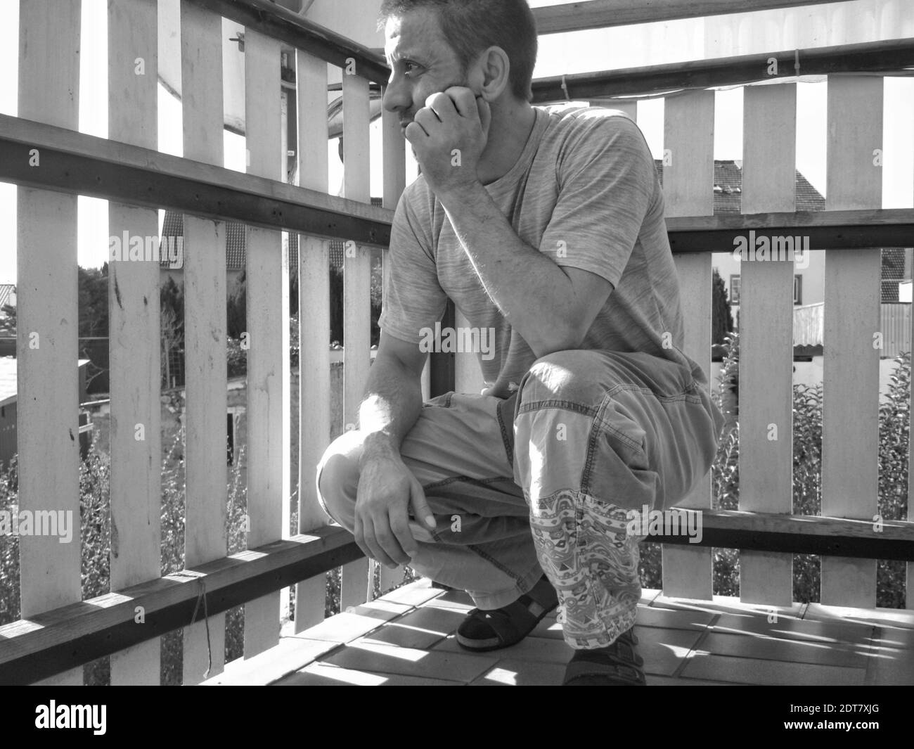 Man sitting on balcony railing Black and White Stock Photos & Images ...