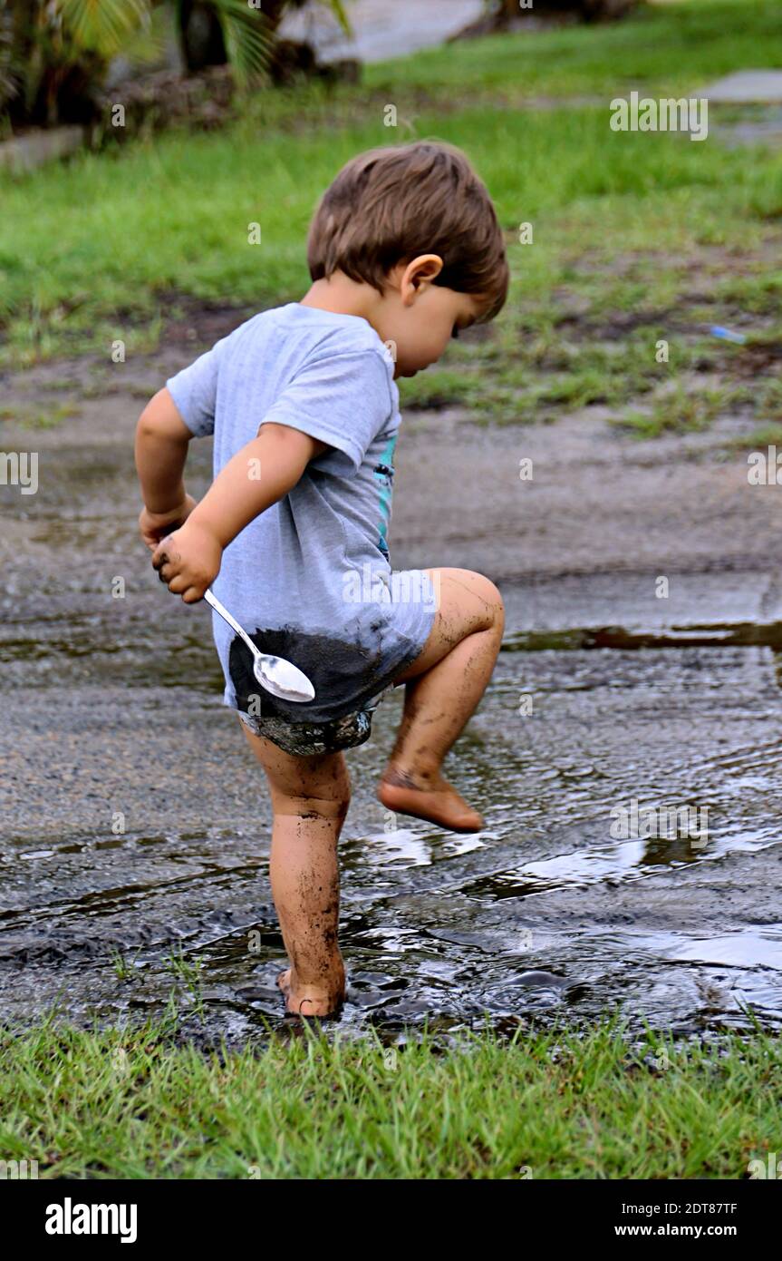 Full Length Of Boy Playing In Mud Stock Photo - Alamy