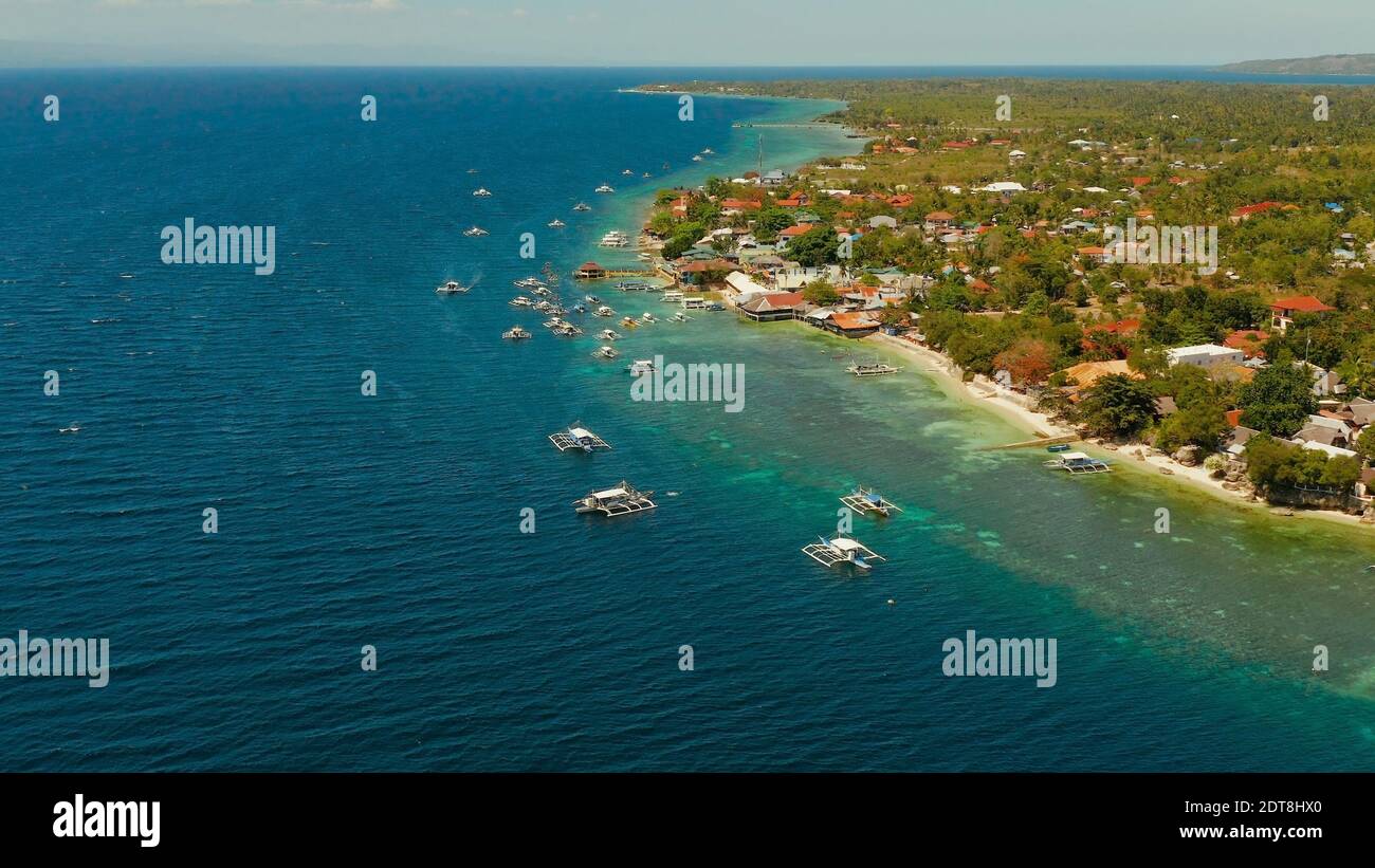 Coral reef and turquoise water with Philippine boats in the famous ...