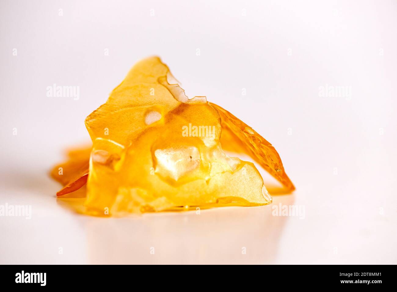 Macro detail of cannabis oil concentrate aka shatter isolated over ...