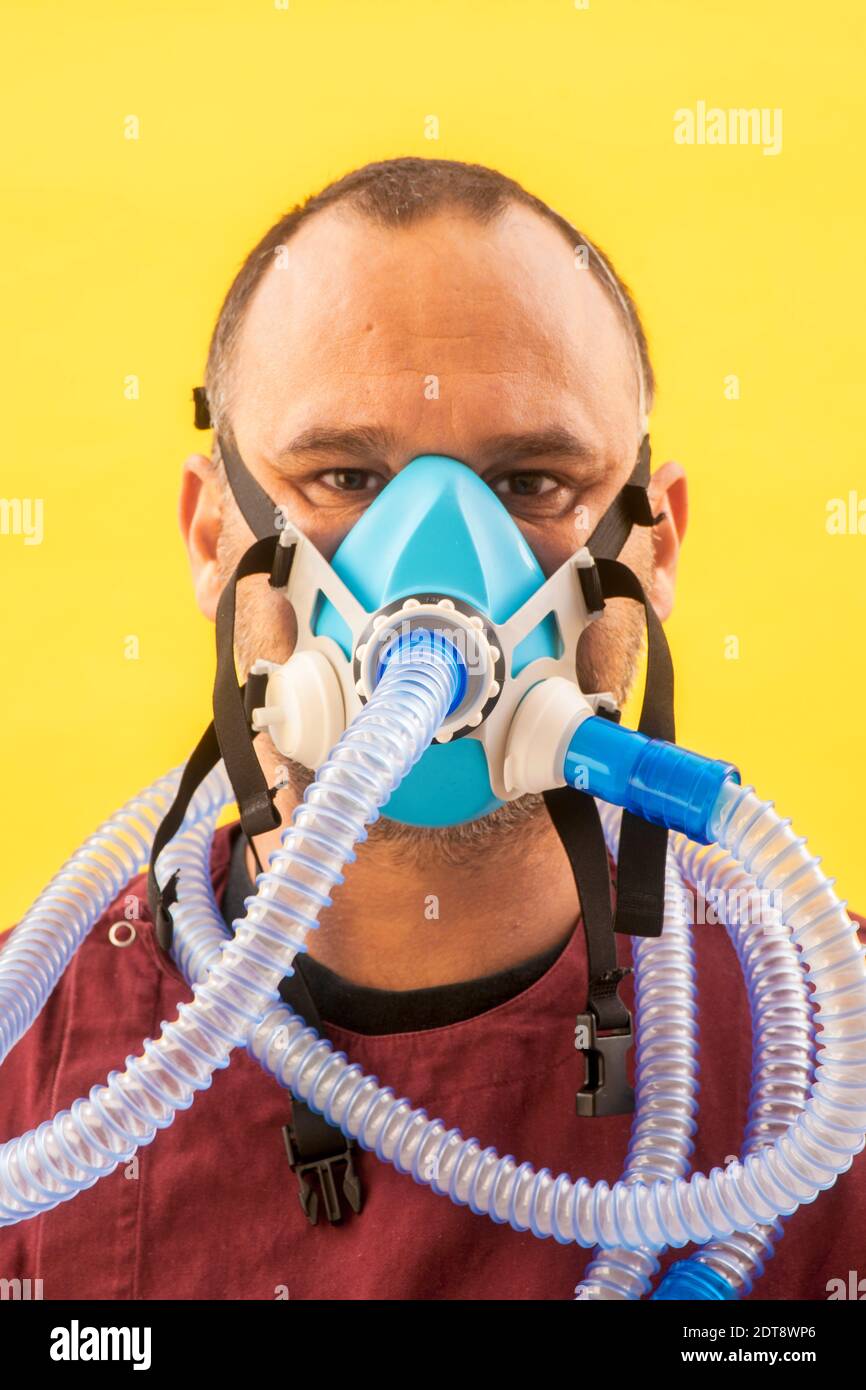 Portrait Of Man Wearing Oxygen Mask Against Yellow Background Stock ...