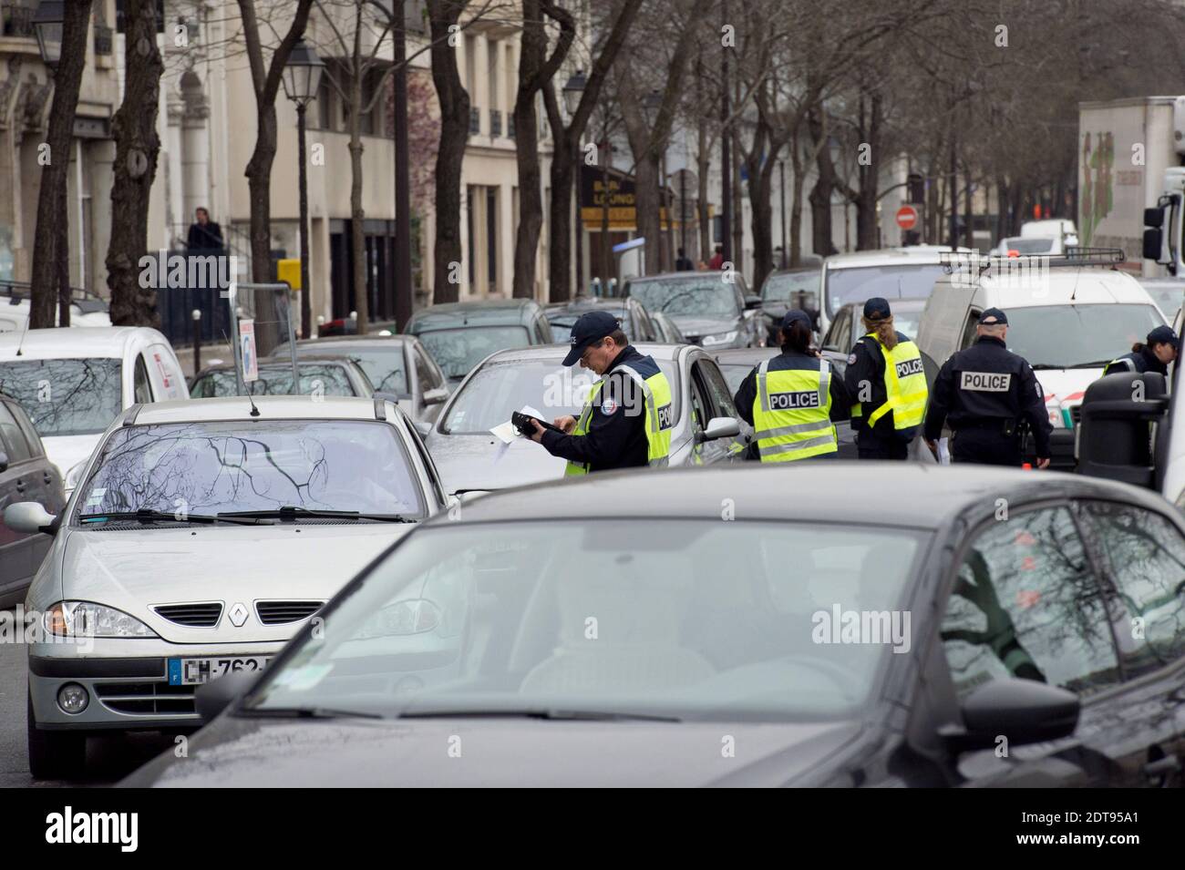 Police officers control cars with number plates ending in even numbers ...