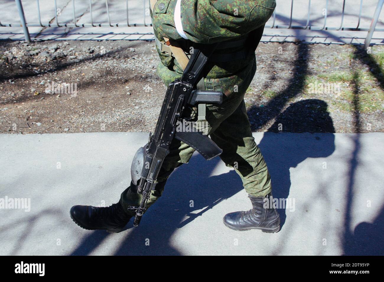 Armed men, believed to be Russian servicemen, stand guard outside a ...