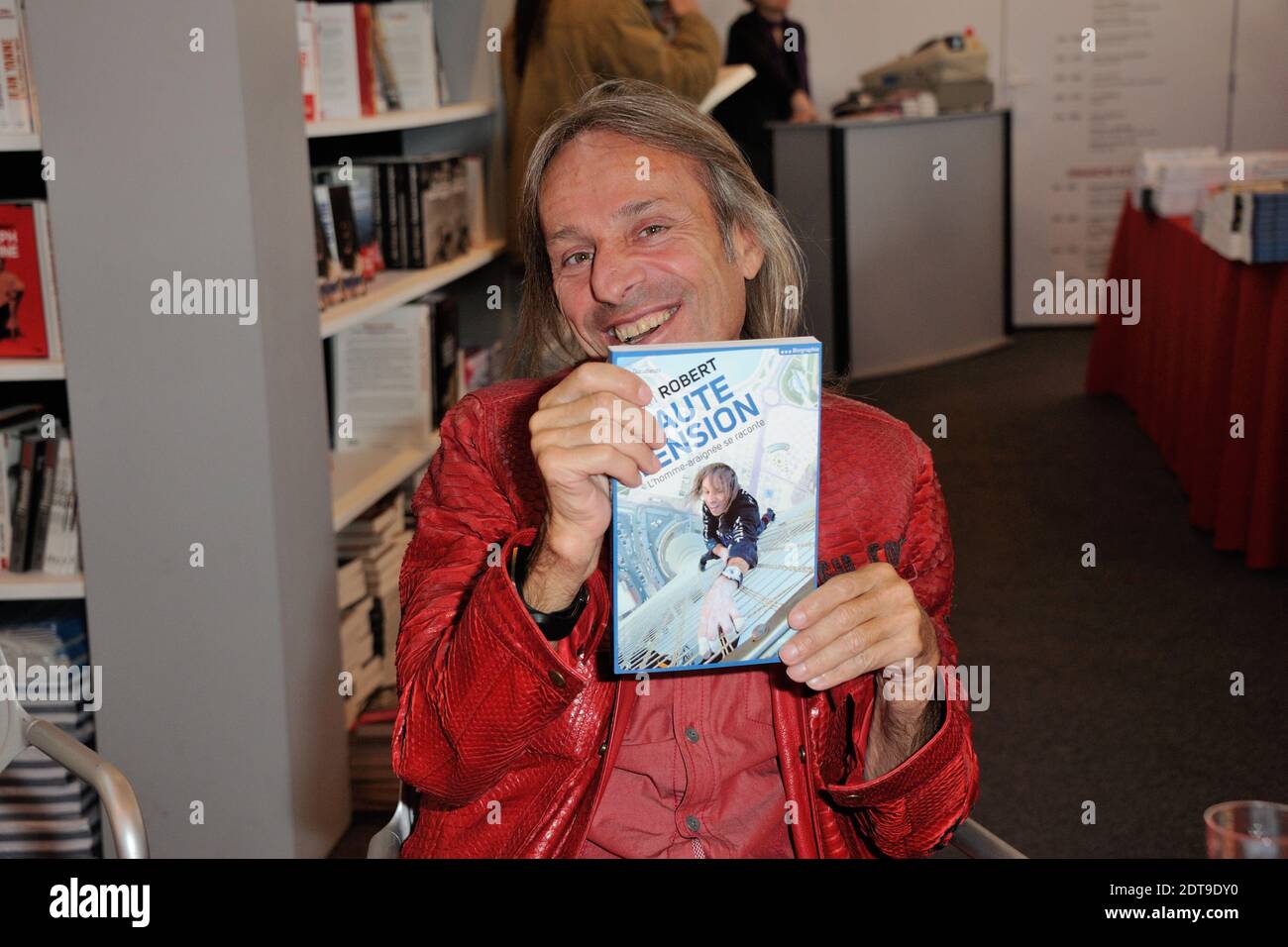 Alain Robert signs copies of his book during the 34th Salon du Livre de ...