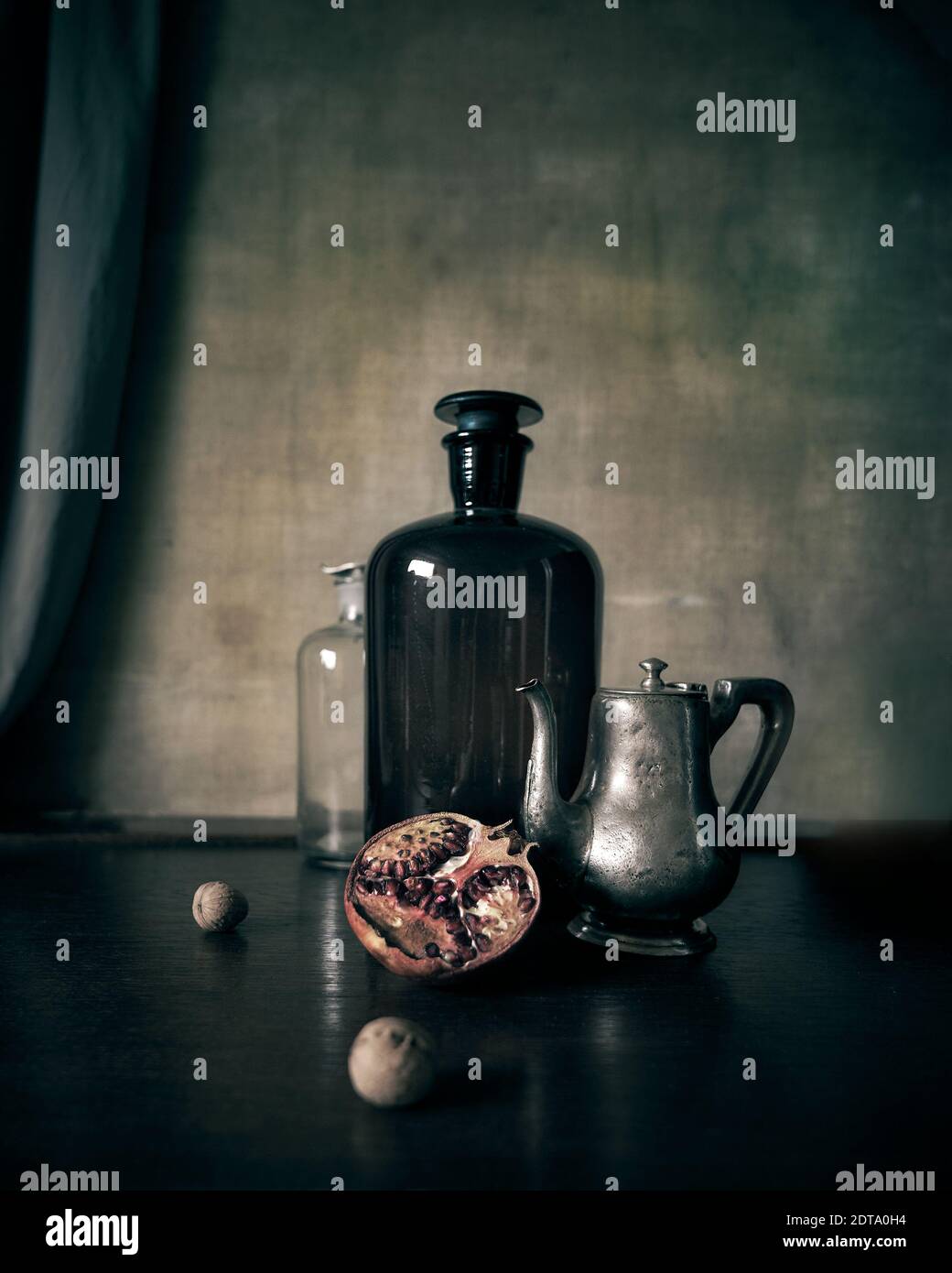 Rustic still life composition with pomegranate fruit a silver kettle ...