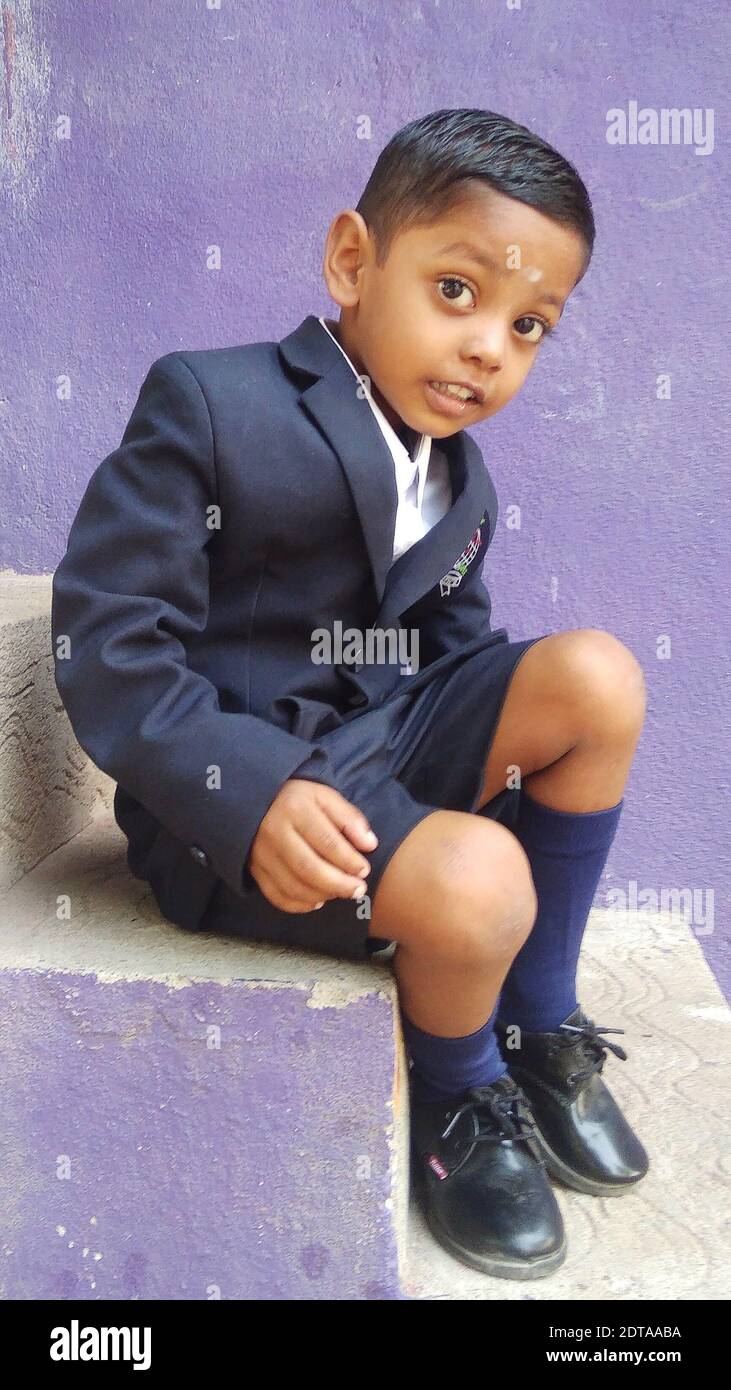 Indian school boy sitting on wall hi-res stock photography and images ...