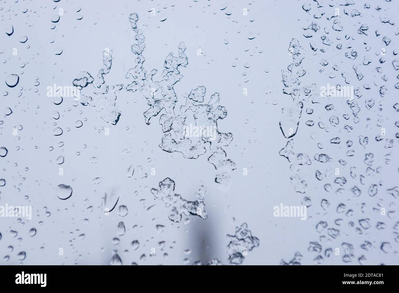 Melting snow on the glass, drops of water condensation on the window ...