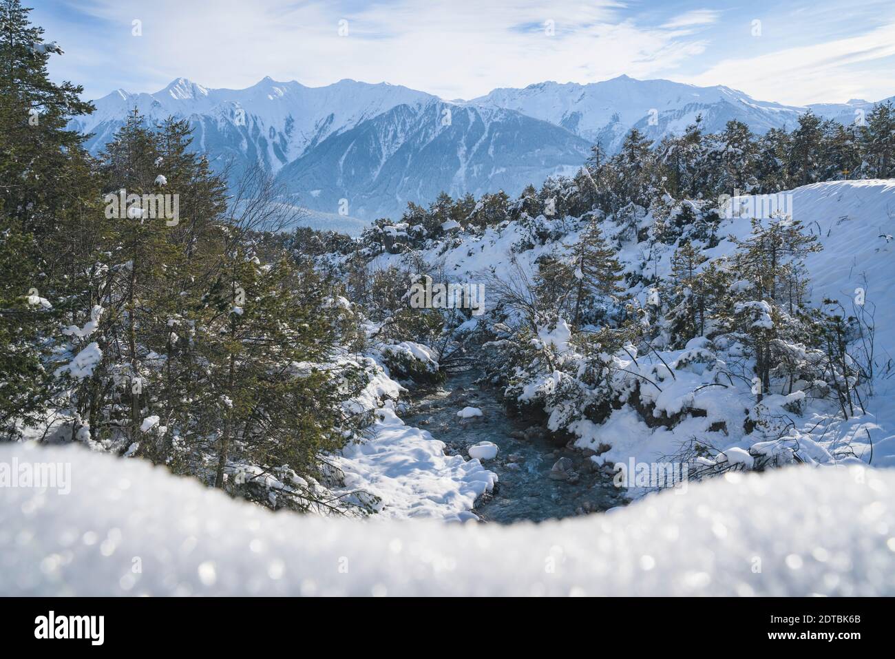 Sunny winter landscape in deep sparkling snow and evergreen trees with ...
