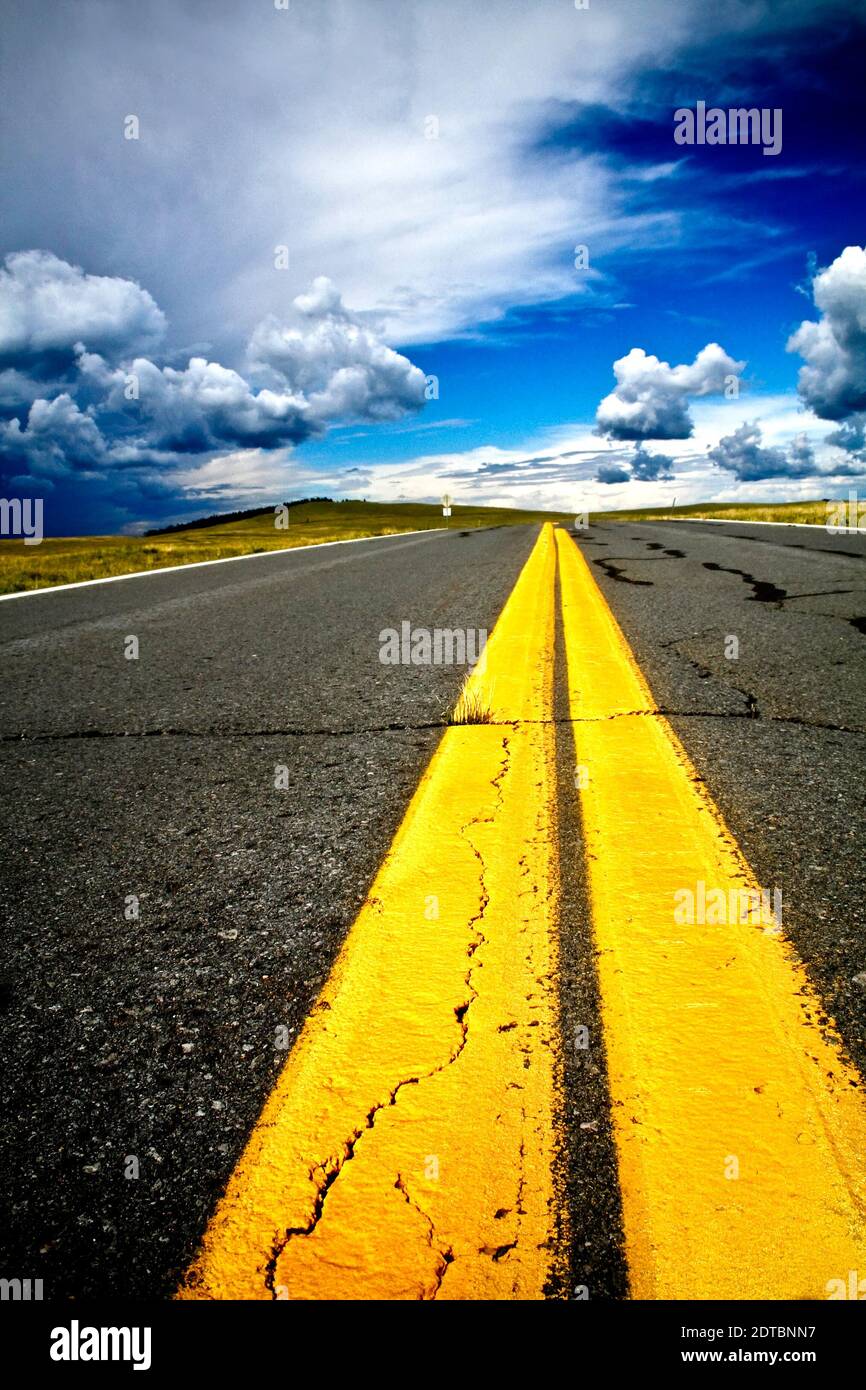 Double Yellow Line On Road Against Cloudy Sky Stock Photo - Alamy