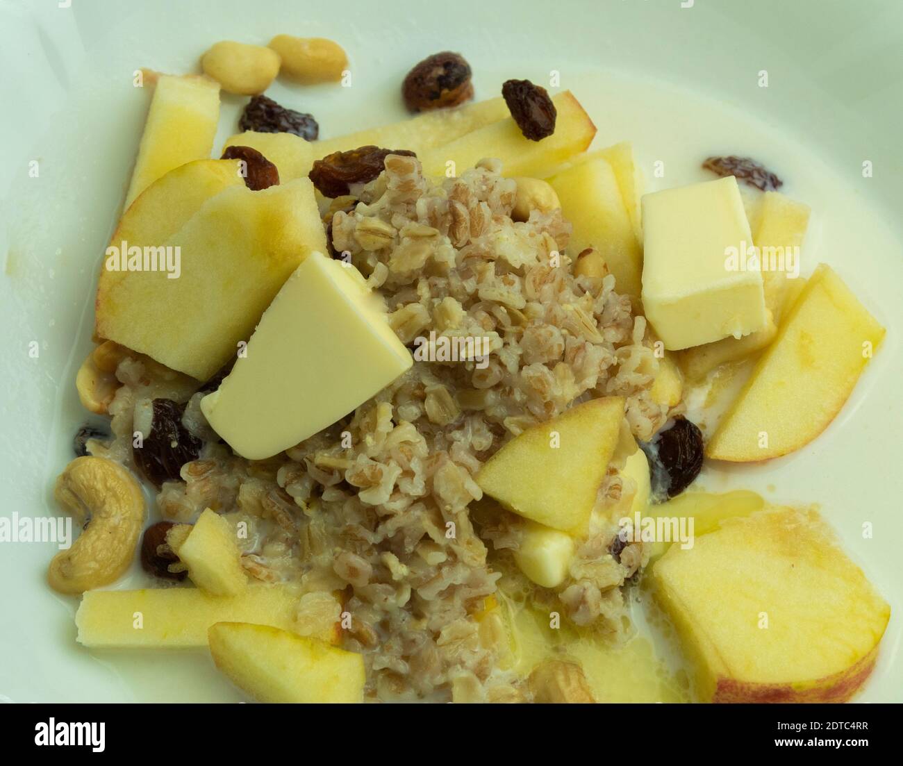 Oatmeal flakes, nuts, butter, milk and fresh fruits Stock Photo - Alamy
