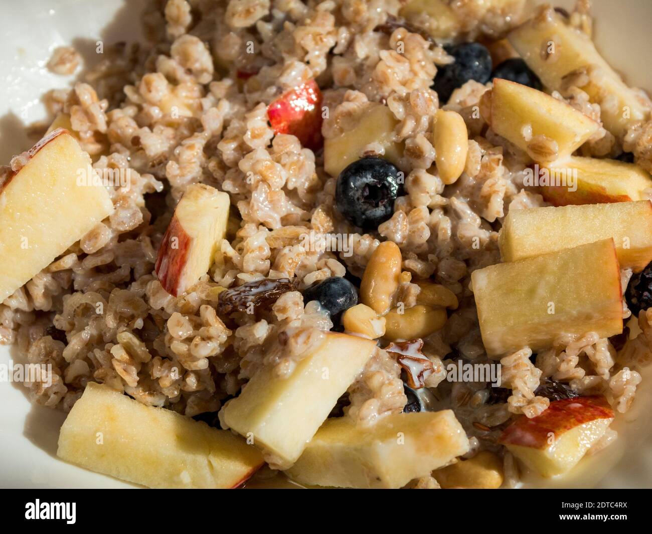 Oatmeal flakes, nuts, butter, milk and fresh fruits Stock Photo - Alamy