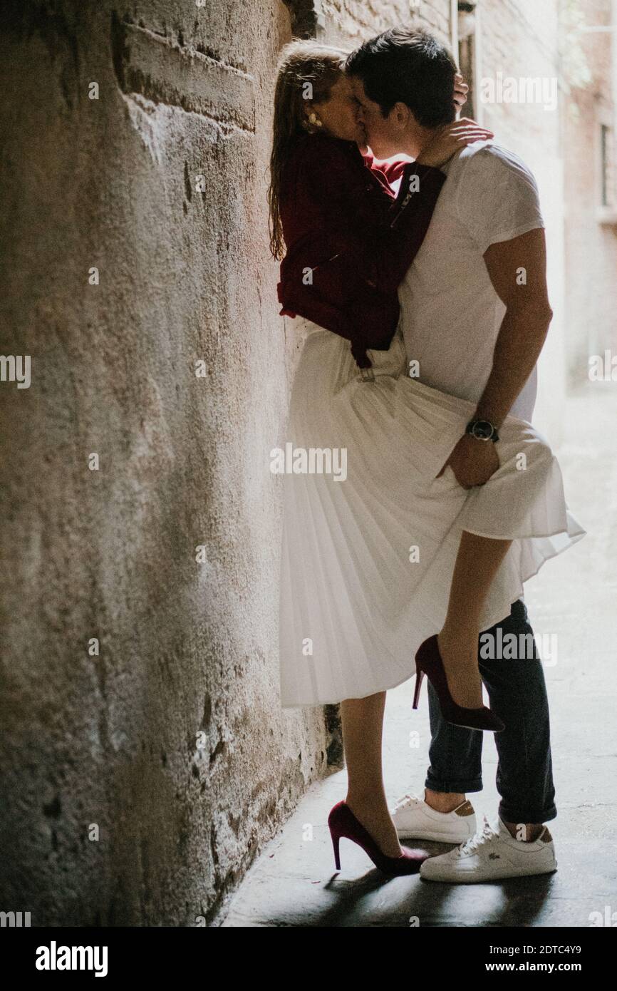 Young Couple Kissing Against Wall High Resolution Stock Photography and Images - Alamy